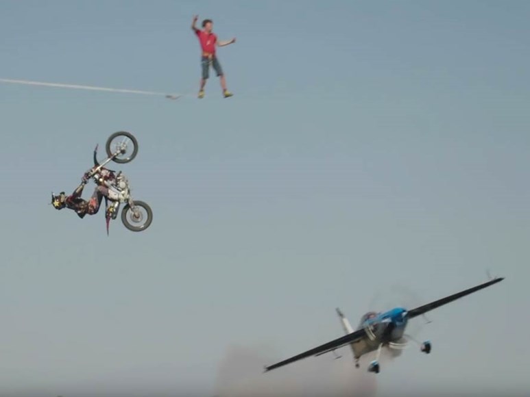 Video: Freestyle motocross rider backflips over stunt plane