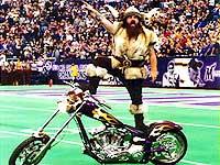 Football mascot leads teams out on a bike